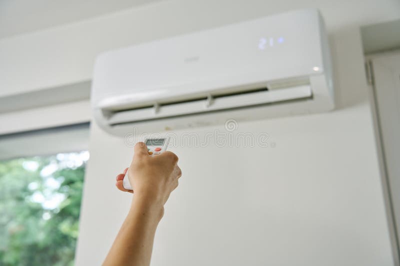 Adjusting Air Conditioner Temperature with Remote Control Stock Image ...