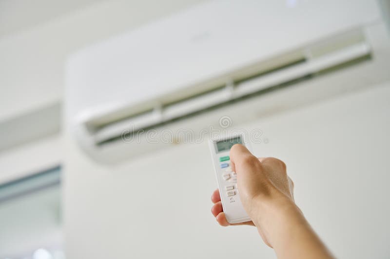 Adjusting Air Conditioner Temperature with Remote Control Stock Photo ...