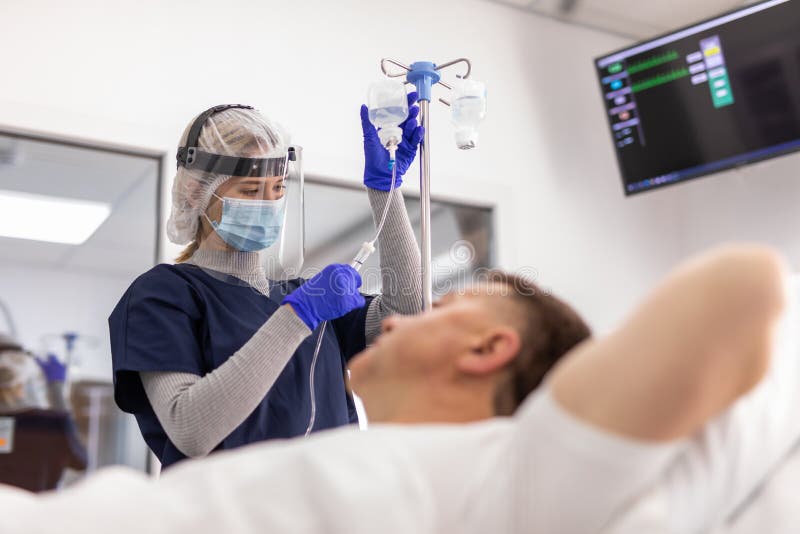 Adjusting the Dropper. Skillful Nurse Preparing Dropper before the ...