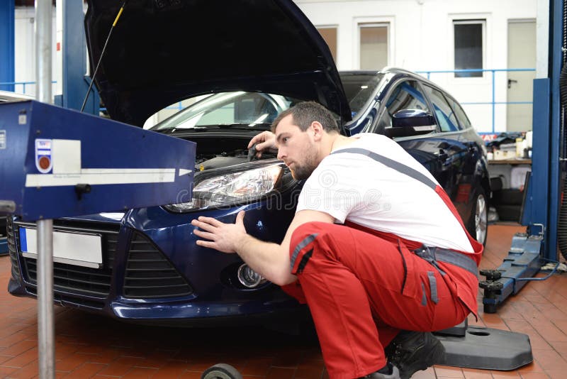 Adjusting the Headlights on the Car by Mechanics in a Garage Stock ...