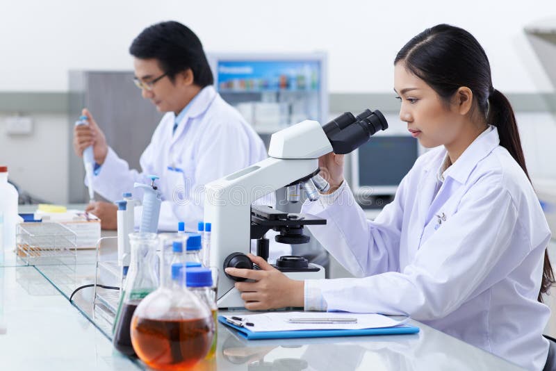 Adjusting microscope stock image. Image of chemist, asian - 58889075