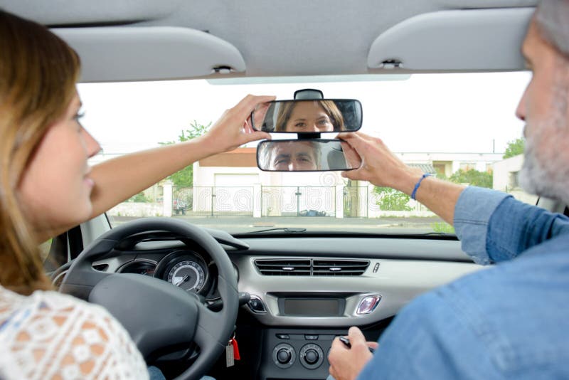 Adjusting the Rear-view Mirrors Stock Photo - Image of adult ...