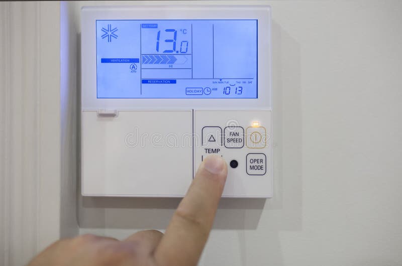 Adjusting Room Climate Control with Electronic Device at Home Stock ...