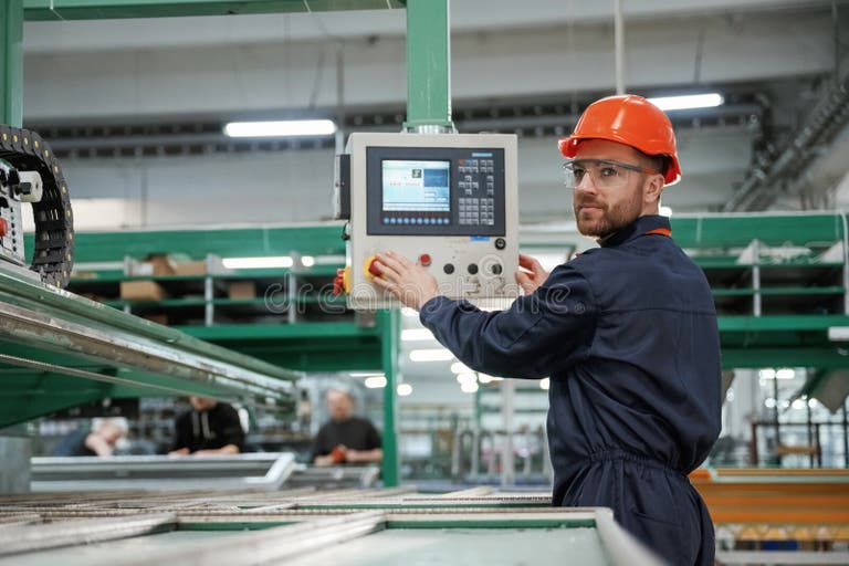 Adjusting Settings of Machine, Operating. Factory Worker is Indoors ...