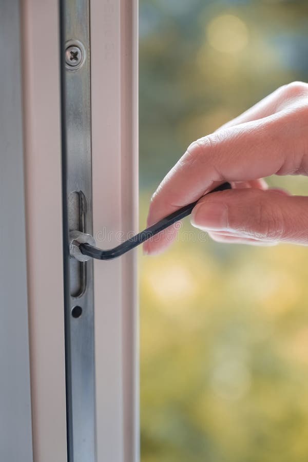 Adjusting the White Plastic Window. a Worker Uses a Hexagon To Repair a ...