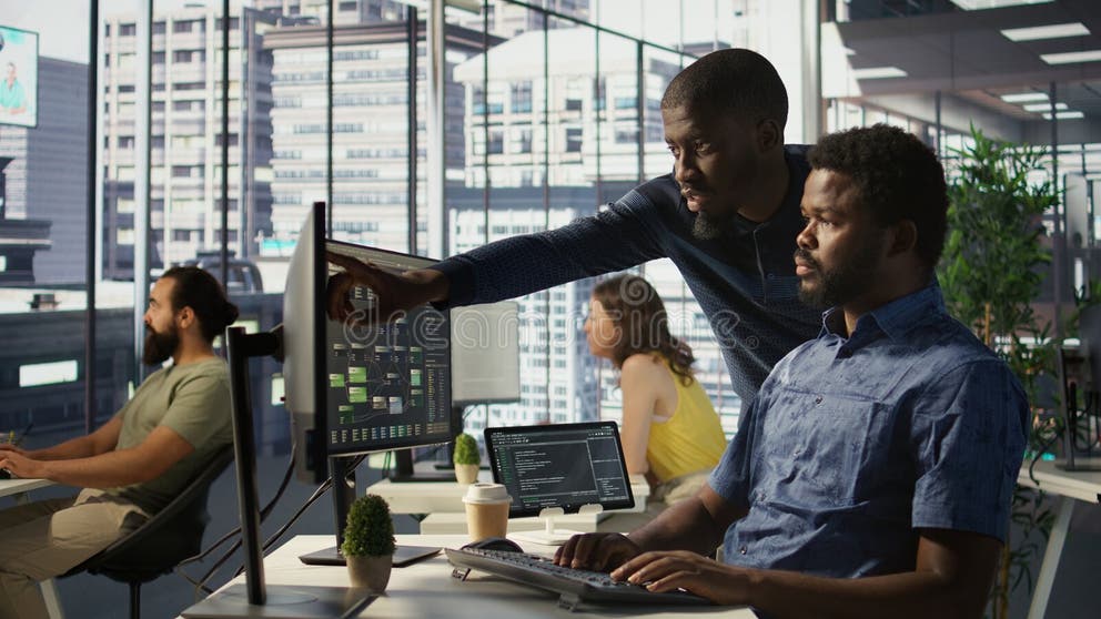 Admin Assisted by Coworker while Working with Machine Learning Stock ...