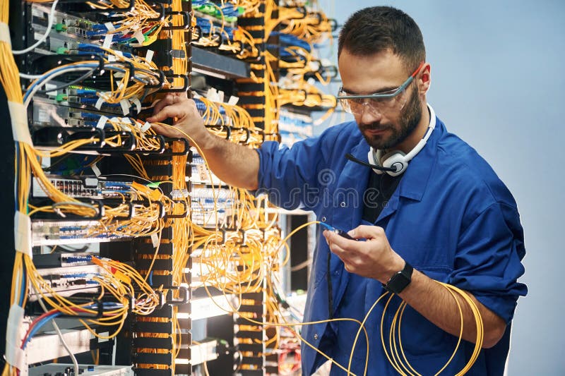 Administrator is Busy. Young Man is Working with Internet Equipment and ...