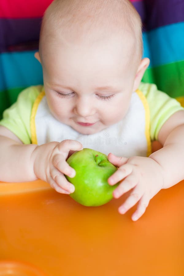 Adorable Baby Eating Apple in High Chair Stock Image - Image of high ...