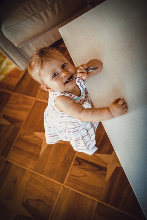 Adorable Baby Girl Standing at Home Stock Image - Image of cute, table ...