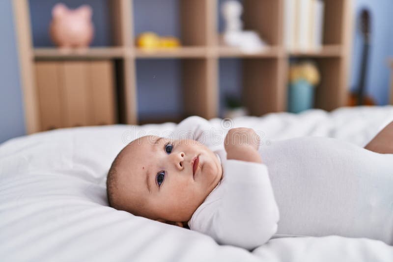 Adorable Baby Relaxed Lying on Bed at Bedroom Stock Image - Image of ...
