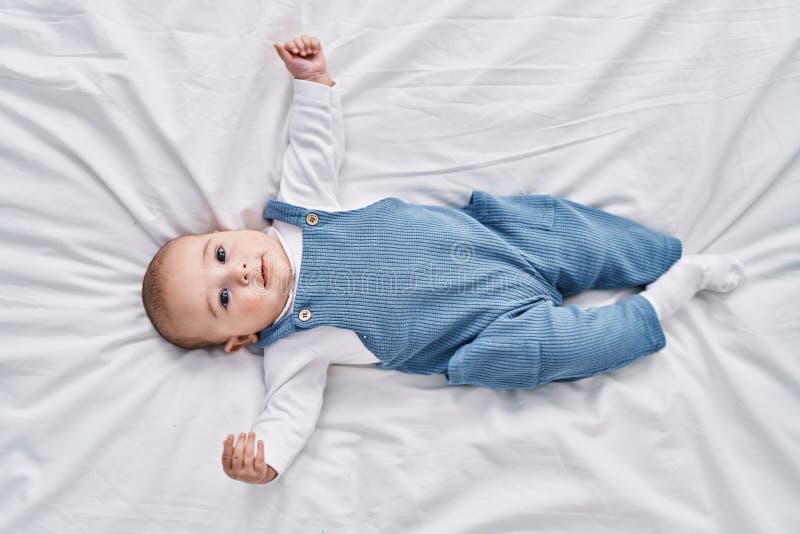 Adorable Baby Relaxed Lying on Bed at Bedroom Stock Photo - Image of ...