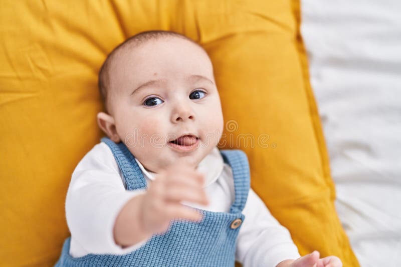 Adorable Baby Smiling Confident Lying on Bed at Bedroom Stock Photo ...