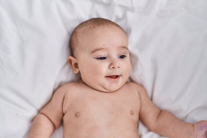 Adorable Baby Smiling Confident Lying on Bed at Bedroom Stock Photo ...