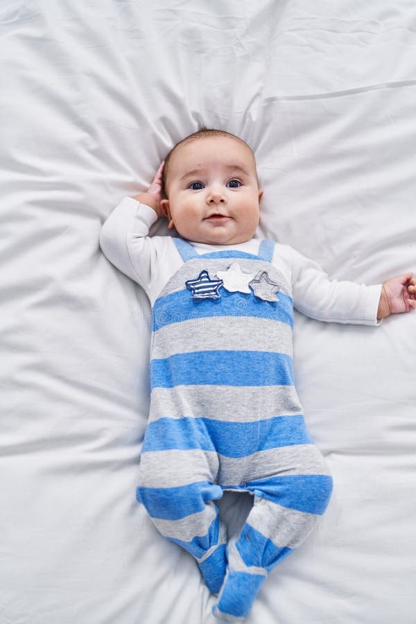 Adorable Baby Smiling Confident Lying on Bed at Bedroom Stock Photo ...