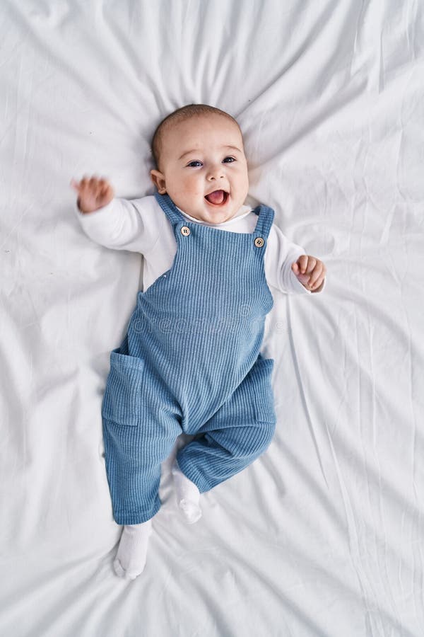Adorable Baby Smiling Confident Lying on Bed at Bedroom Stock Photo ...