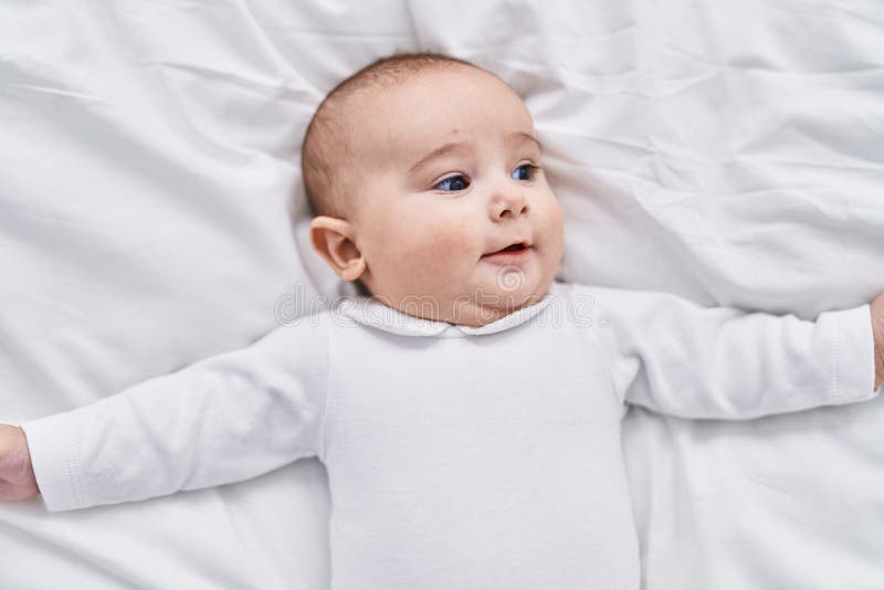 Adorable Baby Smiling Confident Lying on Bed at Bedroom Stock Photo ...