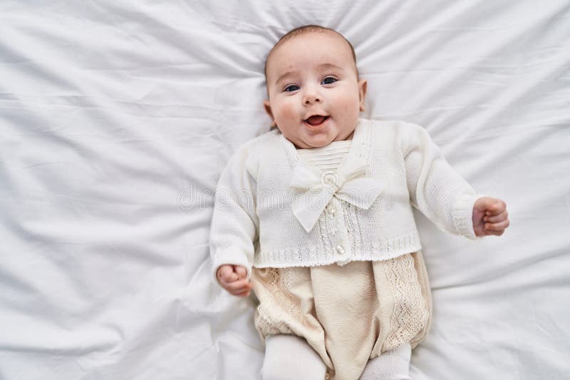 Adorable Baby Smiling Confident Lying on Bed at Bedroom Stock Image ...