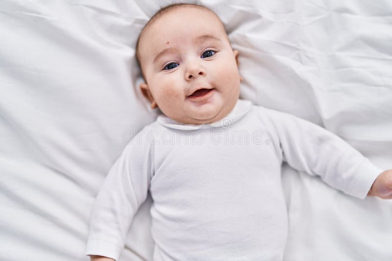 Adorable Baby Smiling Confident Lying on Bed at Bedroom Stock Image ...