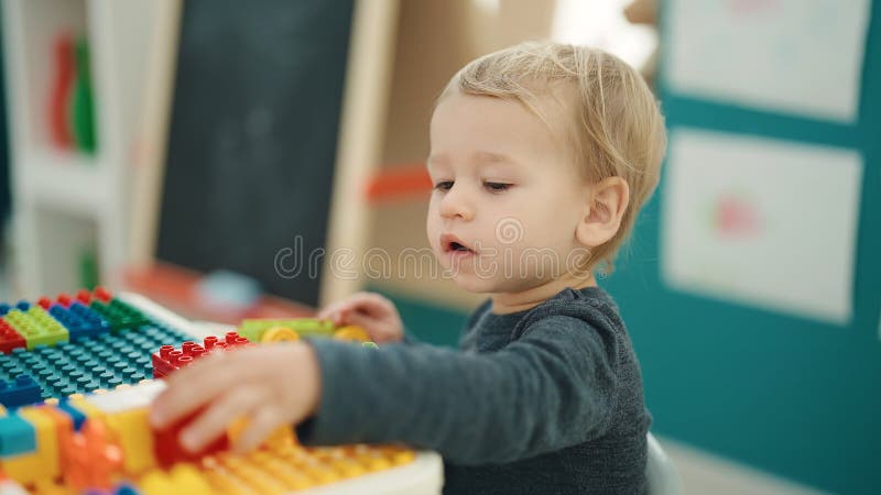 Adorable Blond Toddler Playing with Construction Blocks Sitting on ...