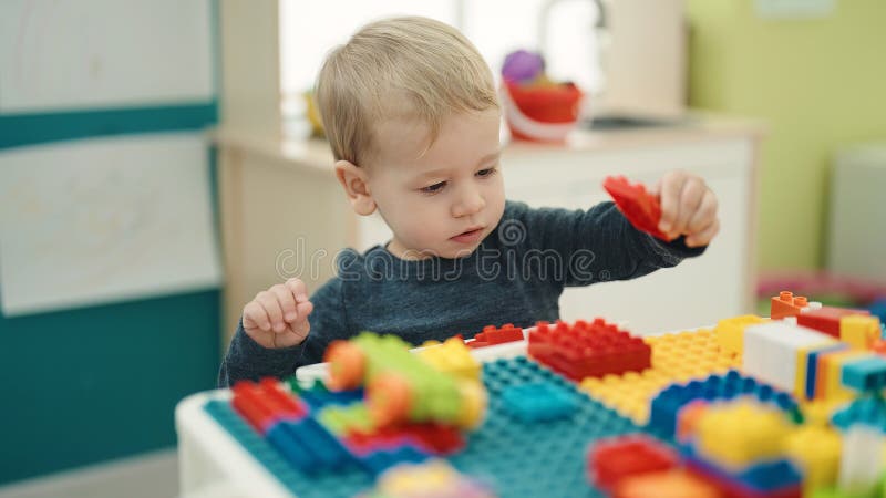 Adorable Blond Toddler Playing with Construction Blocks Sitting on ...