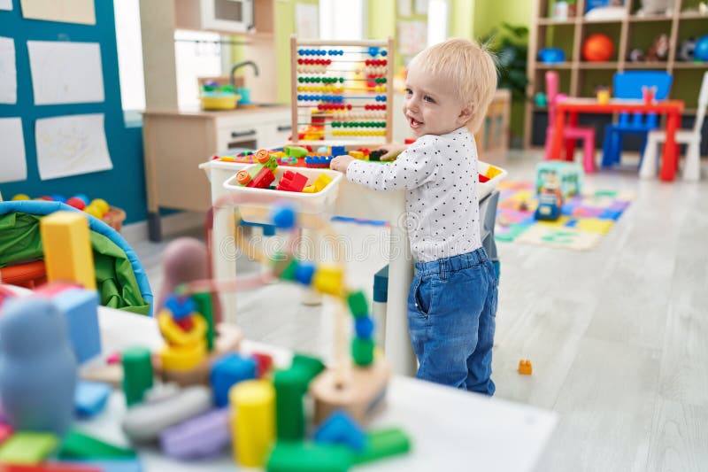 Adorable Blond Toddler Playing with Construction Blocks Standing at ...