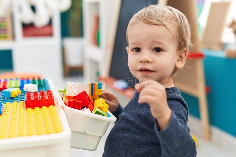Adorable Blond Toddler Playing with Construction Blocks Standing at ...