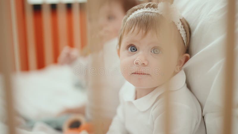 Adorable Blonde Baby Sitting on Cradle at Bedroom Stock Image - Image ...
