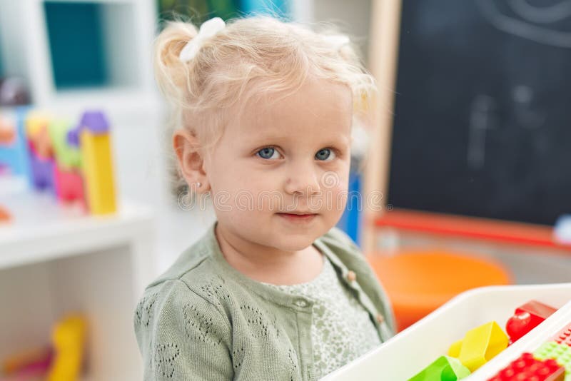 Adorable Blonde Girl Playing with Construction Blocks Sitting on Table ...