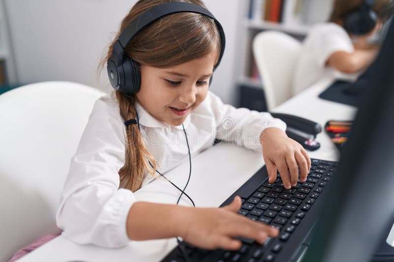 Adorable Blonde Girl Student Using Computer Sitting on Table at ...