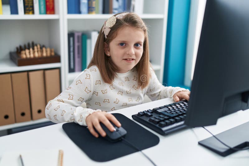 Adorable Blonde Girl Student Using Computer Sitting on Table at ...