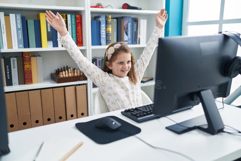 Adorable Blonde Girl Student Using Computer with Winner Expression at ...