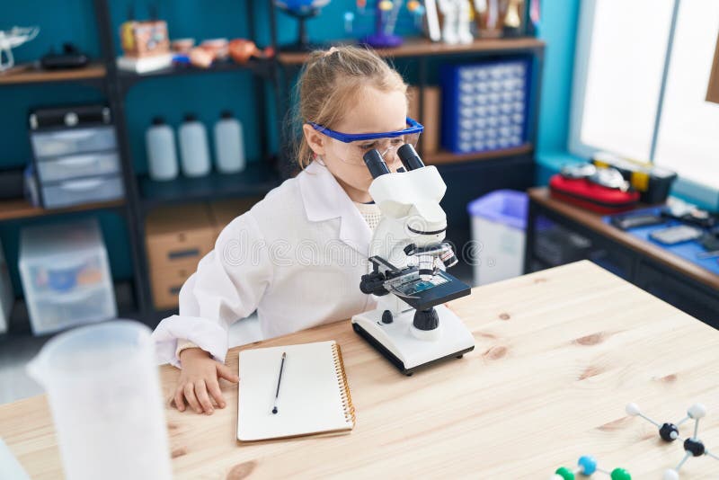 Adorable Blonde Girl Student Using Microscope at Laboratory Classroom ...