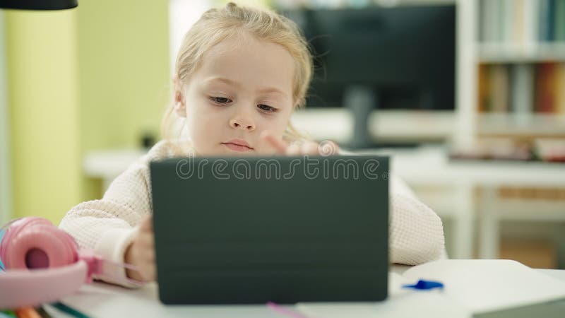Adorable Blonde Girl Student Using Touchpad Sitting on Table at ...