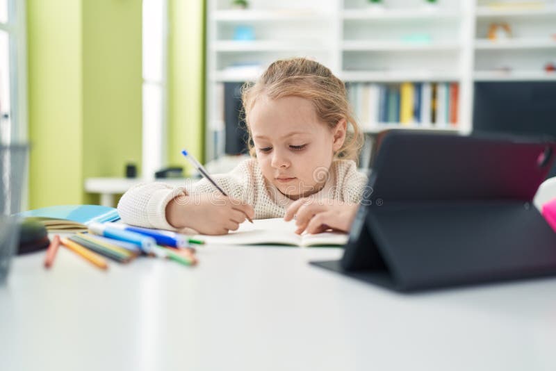 Adorable Blonde Girl Student Using Touchpad Writing on Notebook at ... Adorable Blonde Girl Student Using Touchpad Writing on Notebook at ...