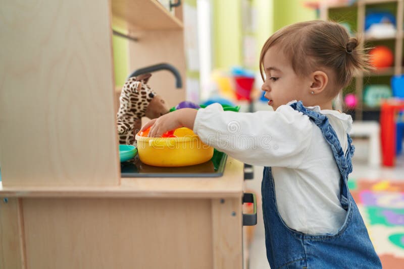 Adorable Blonde Toddler Playing with Play Kitchen Standing at ...