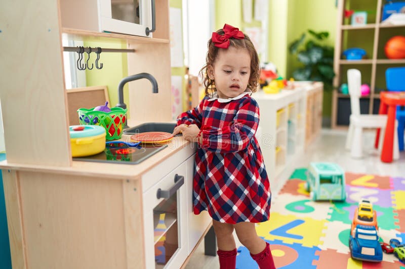 Adorable Blonde Toddler Playing with Play Kitchen Standing at ...