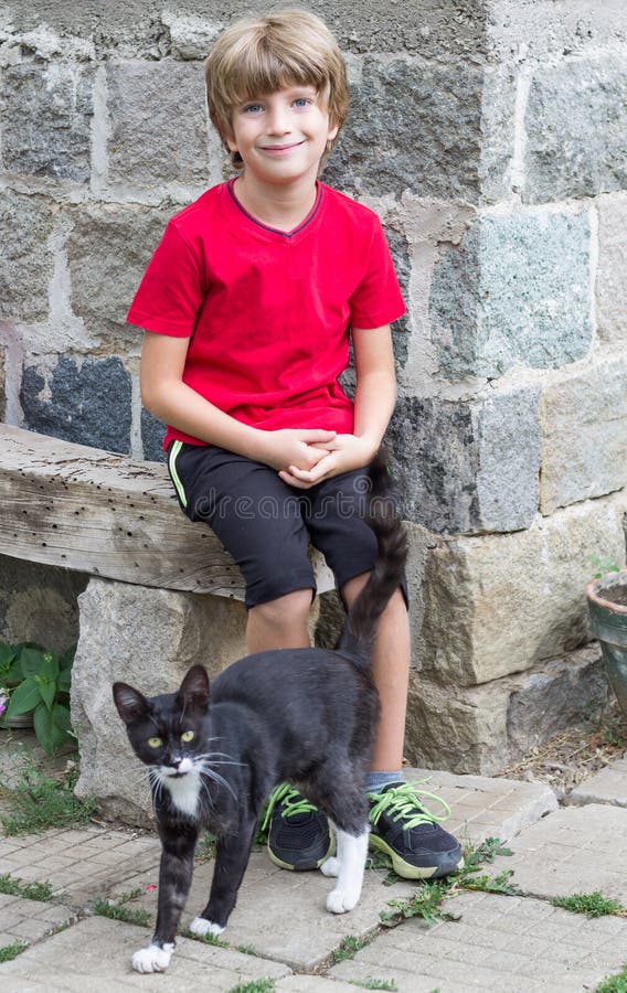 Adorable boy and a cat stock image. Image of cute, face - 168902619
