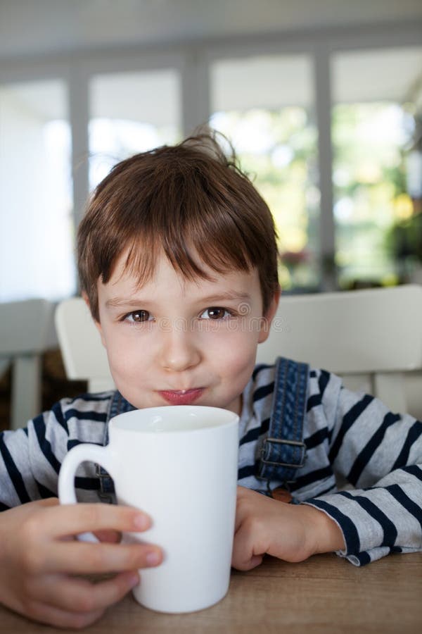 Adorable boy drinking stock photo. Image of holding, funny - 84218488