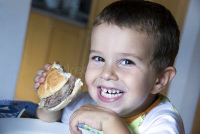 Adorable Boy Eating Cheeseburger Stock Image - Image of childhood ...