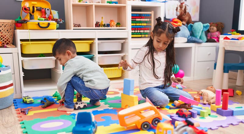 Adorable Boy and Girl Playing with Construction Blocks at Kindergarten ...
