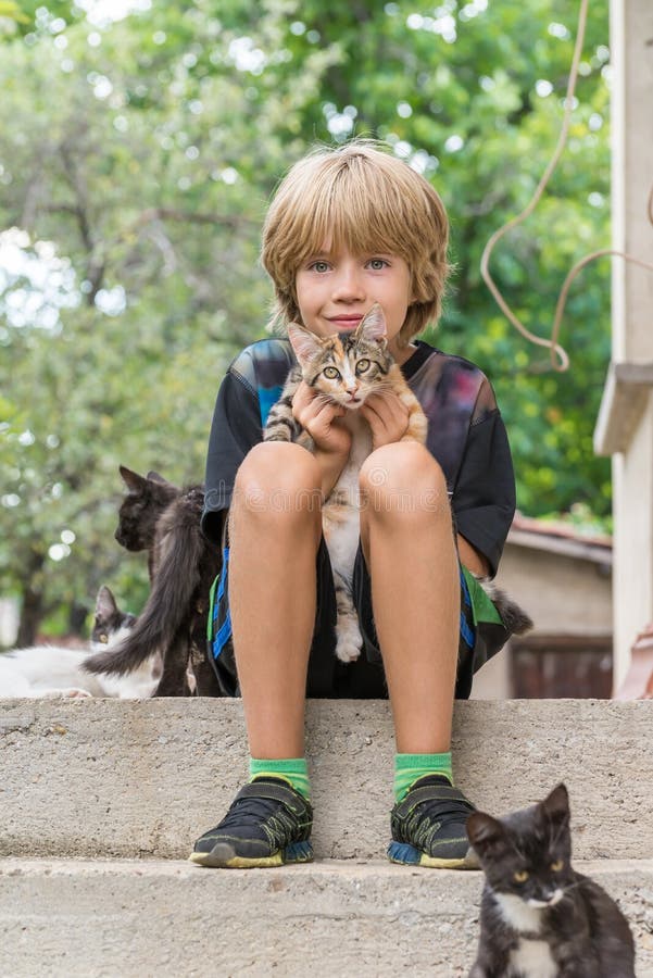 Adorable Boy Holding a Kitten Stock Photo - Image of care, adorable ...