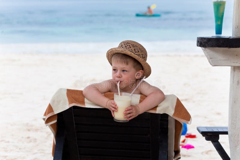 Adorable Boy Sipping Milkshake Stock Photo - Image of child, lounge ...