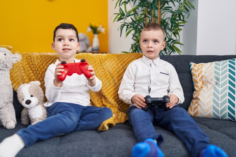 Adorable Boys Playing Video Game Sitting on Sofa at Home Stock Image ...