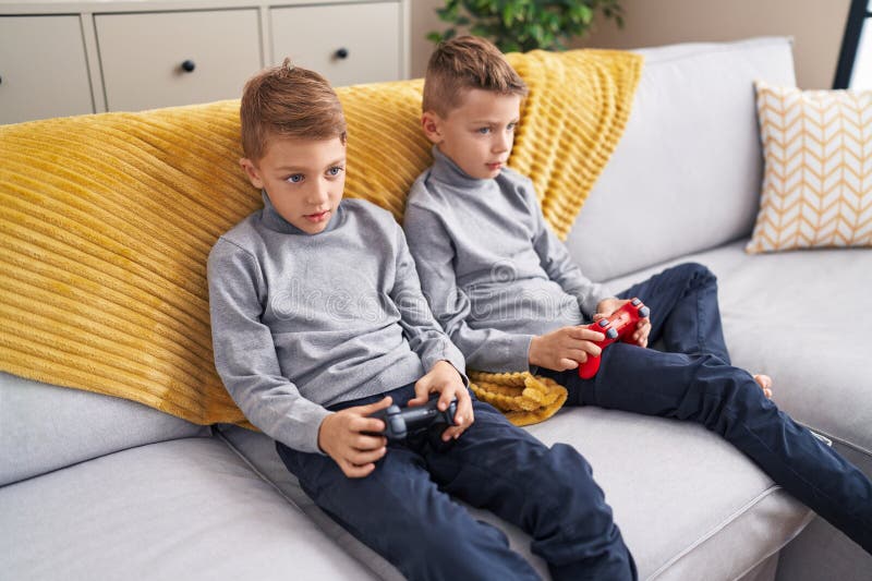 Adorable Boys Playing Video Game Sitting on Sofa at Home Stock Image ...