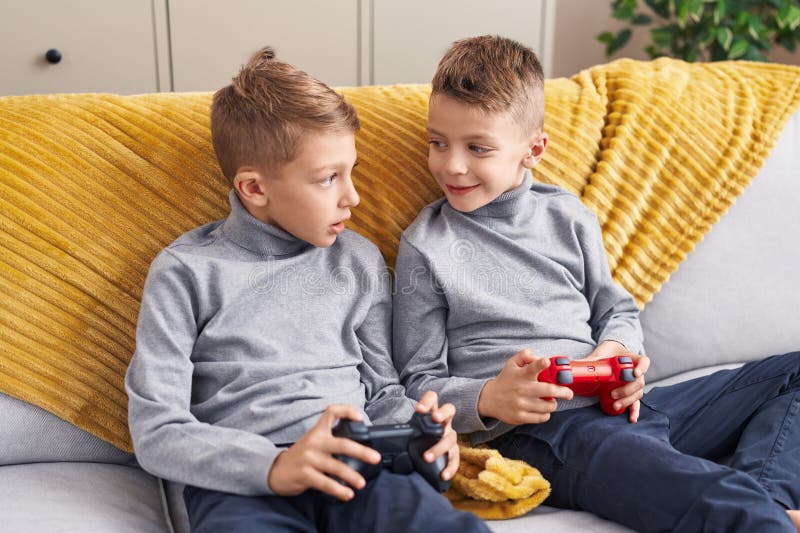 Adorable Boys Playing Video Game Sitting on Sofa at Home Stock Image ...