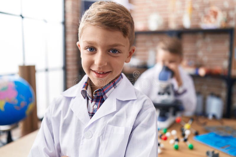Adorable Boys Students Using Microscope Writing Notes at Laboratory ...
