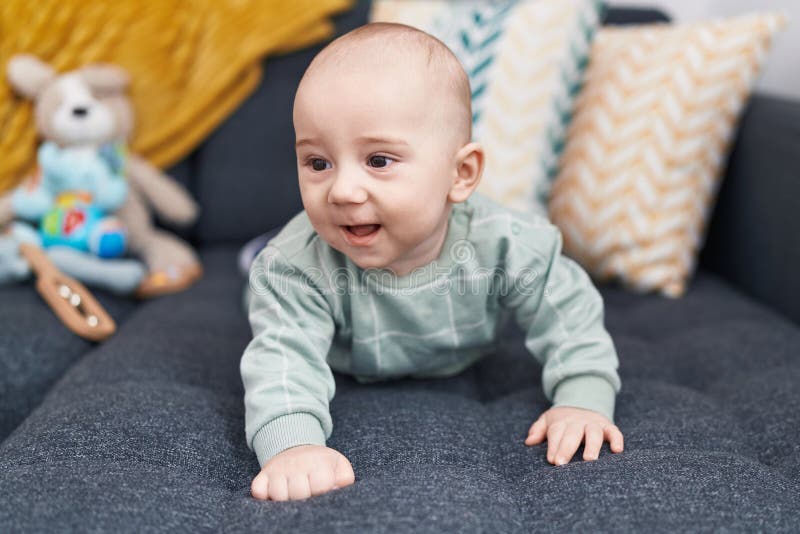 Adorable Caucasian Baby Crawling on Sofa at Home Stock Photo - Image of ...