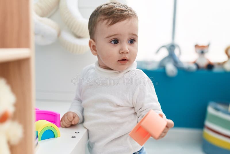 Adorable Caucasian Baby Playing with Construction Blocks Standing at ...