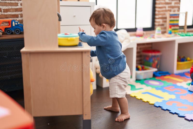 Adorable Caucasian Baby Playing with Play Kitchen Standing at ...
