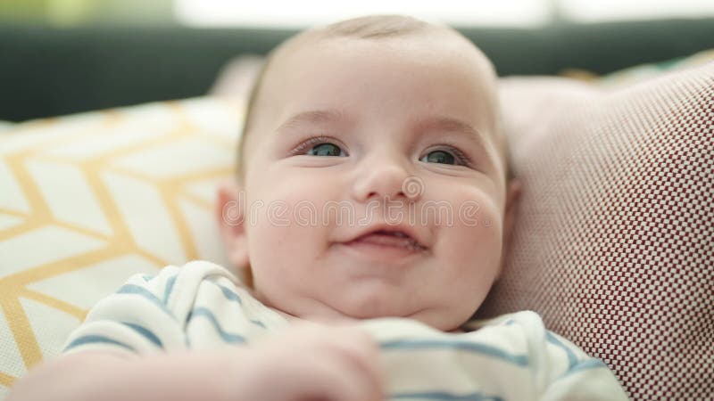 Adorable Caucasian Baby Smiling Confident Lying on Sofa at Home Stock ...